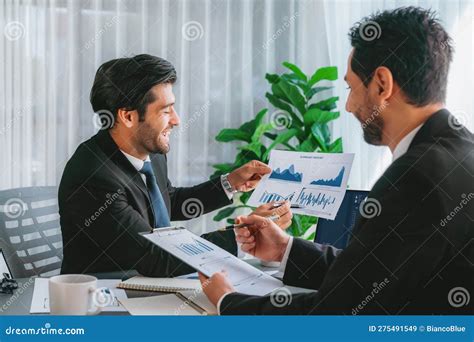 Busy Analyst Team Discussing Financial Data On Laptop Fervent Stock