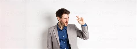 Businessman Trying To See Something Tiny Showing Little Thing Size