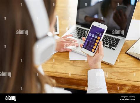 Business Woman With Calculator On Laptop Computer Doing A Calculation In The Home Office Stock