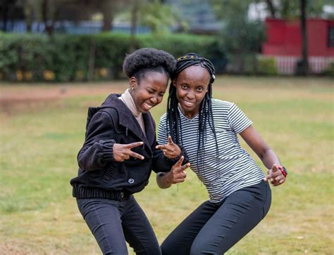 Young Girls Standing On Green Field While Posing At The Camera · Free