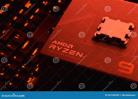 A Close Up Of An Amd Ryzen 9 3900x Processor In A Packaging Box With Backlit Keyboards In The