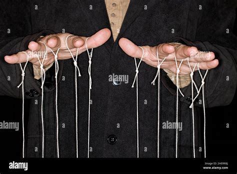 String Pulling Puppeteer Studio Photography With Black Background Stock Photo Alamy