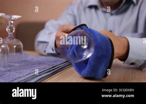 Man Polishing Wine Glass With Cloth After Washing Removing Water Drops
