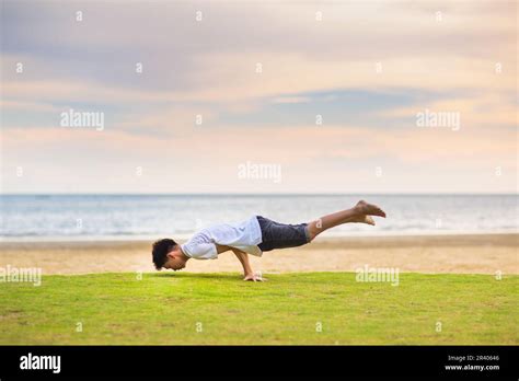 Teenager Doing Calisthenics Exercise Beach Yoga At Sunset Teen Boy