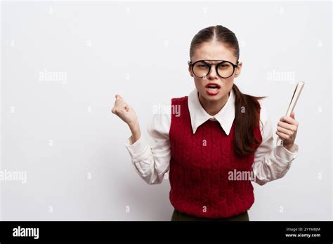 Angry Girl With Glasses Holding A Book Expressing Frustration White