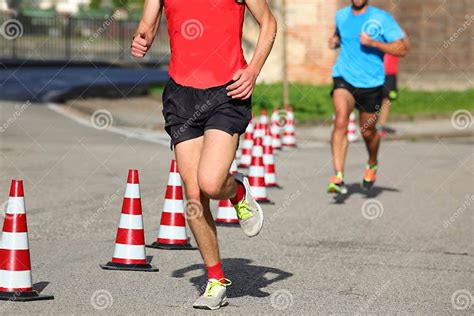Athletic Runner With Long Muscular Legs During The Foot Race Stock