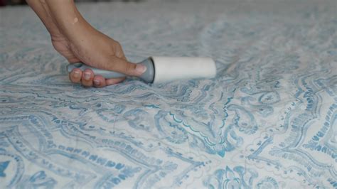Using An Adhesive Roller To Remove Lint And Fluff From A Bed 35719512 Stock Video At Vecteezy