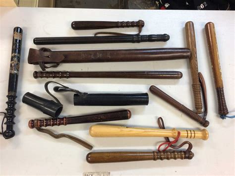 Lot 620 Two Mounted Police Batons In Leather Sheaths
