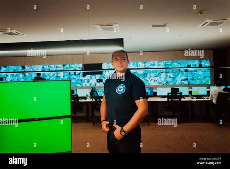 Male Security Operator Working In A Data System Control Room Offices Technical Operator Working