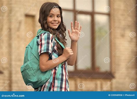 Cute Happy Girl With Long Hair In Casual Style Carry Travel Bag Waving