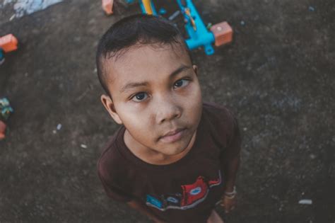 Premium Photo High Angle Portrait Of Boy Standing Outdoors