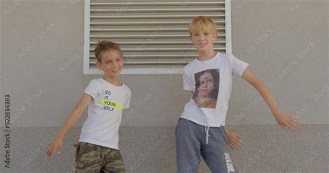 Portrait Of Cute Smiling Preteen Boys Posing Together Make Dance