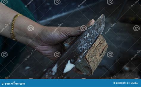 Peeling Off The Skin Of Cassava Preparation For Cooking Left Hand With Gold Bracelet Holding