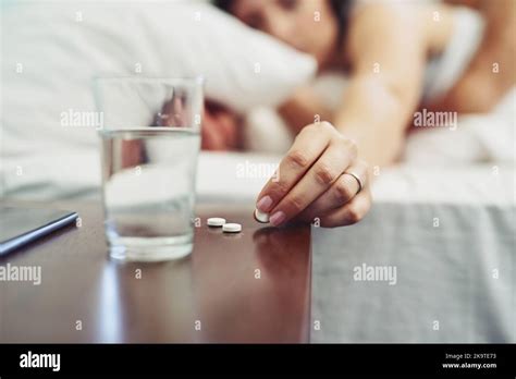 Goodbye Headache An Unrecognizable Woman Lying In Bed And Taking A Pill To Drink After Waking