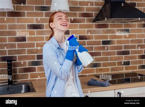 Caucasian Redhaired Ginger Housewife In Casual Clothes And Gloves