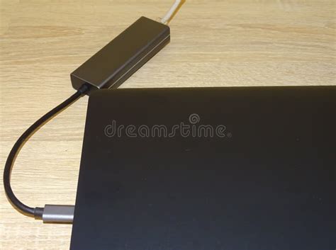 Internet Cable Connected To A Multi Functional USB C Hub Station Ethernet Which Is Connected