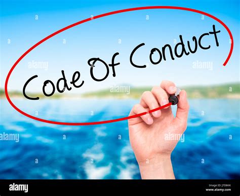 Man Hand Writing Code Of Conduct With Black Marker On Visual Screen