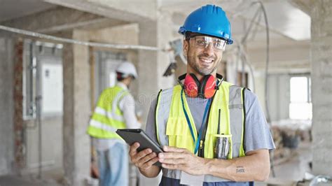 Two Men Builders Smiling Confident Using Touchpad At Construction Site Stock Image Image Of