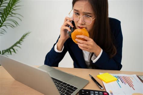 Premium Photo Busy And Tired Businesswoman Eating Bread And Milk For