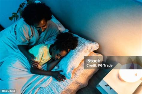 Mother Looking Her Daughter While Shes Sleeping In The Bedroom At Home