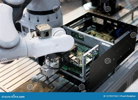 robotic arm installing a computer chip in factory industrial an stock