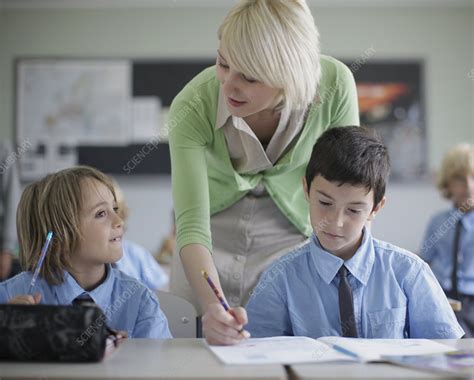 Female Teacher Correcting Student Work Stock Image F0031680