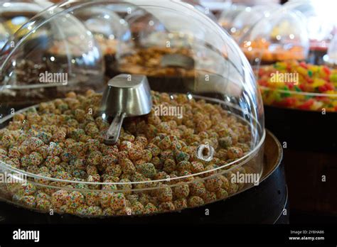 Colorful Assortment Of Candies In Glass Bowls At A Candy Store Stock