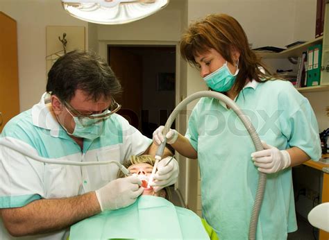 Dentist And His Assitent During Examination Stock Image Colourbox