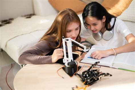 Premium Photo Portrait Of Teenage Girls Students Studying With Robot Premium Photo Portrait Of Teenage Girls Students Studying With Robot