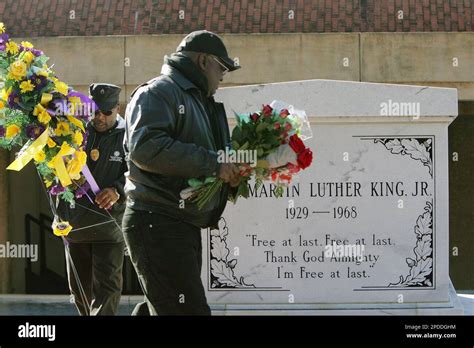 King Center Employee Bobby Blacklock Right And An Unidentified Security Officer Bring Flowers