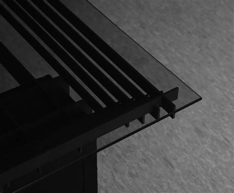 Gridded Steel Frames Slice Through Charred Timber Bases For Lin Tables