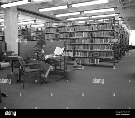 1960s Historical A Young Woman Alone In A Large Modern Library