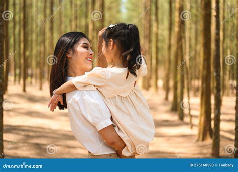Madre Sosteniendo A Una Linda Hija Y Riendo Juntos En Un Parque De
