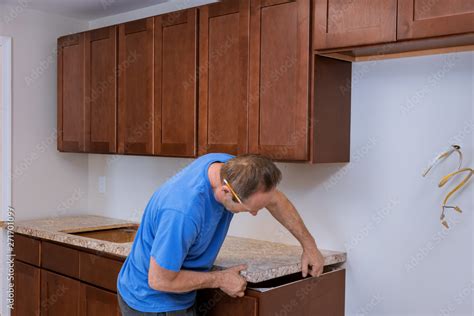 Carpenter Installing C Counter Top In A Kitchen Stock Photo Adobe Stock