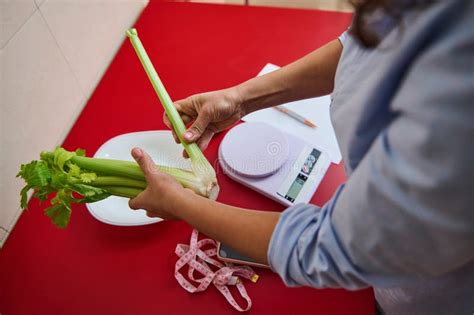 Preparing Fresh Celery For Healthy Meal Planning And Cooking Stock