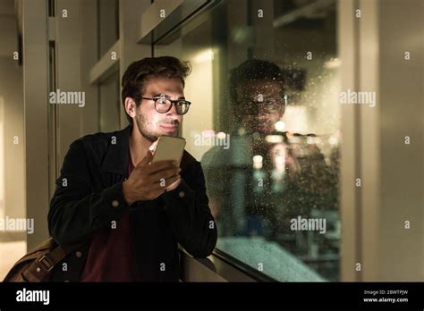 Man Looking Out Window At Night