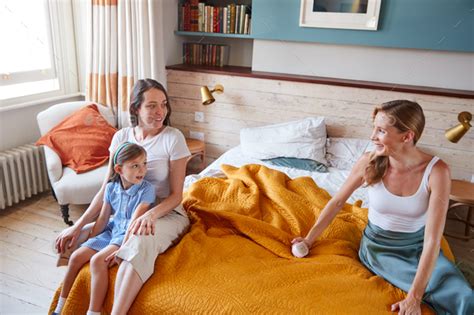 Same Sex Female Couple At Home Getting Daughter Ready For School