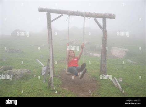 Girl Swinging On A Swing In A Natural Shade And A Foggy Field Stock Photo Alamy