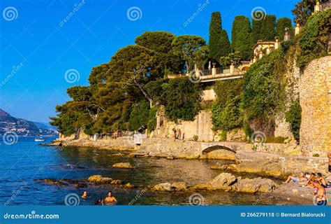 Rocky Shoreline With People Sunbathing Near Plage Paloma Beach In Saint Jean Cap Ferrat Resort