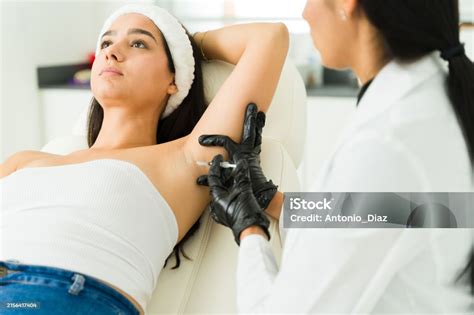 Female Patient Receives A Botulinum Toxin Injection For Hyperhidrosis From A Doctor In A Clinic