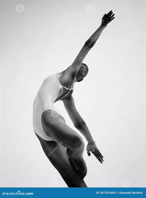 Young Ballerina In A Bodysuit Shows Ballet Steps In Motion Standing On
