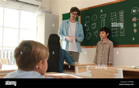 Student Standing At In Front Of Class And Start To Introduce Himself At