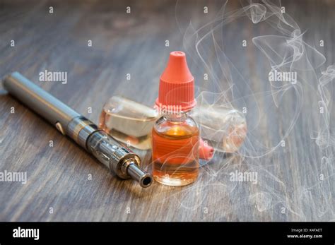 An Electronic Cigarette A Vape And Several Bottles Of Liquid For