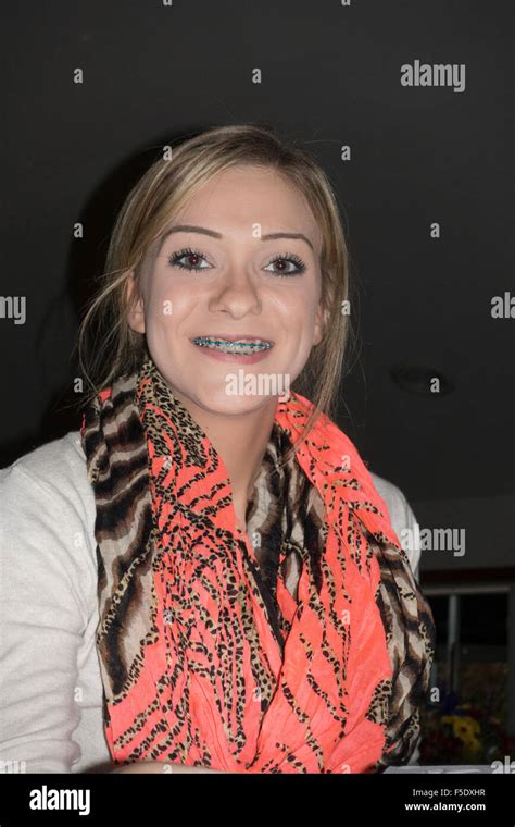 Smiling Portrait Of Teenage Waitress Wearing Braces On Her Teeth And