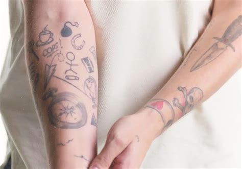A Person With Many Tattoos On Their Arms