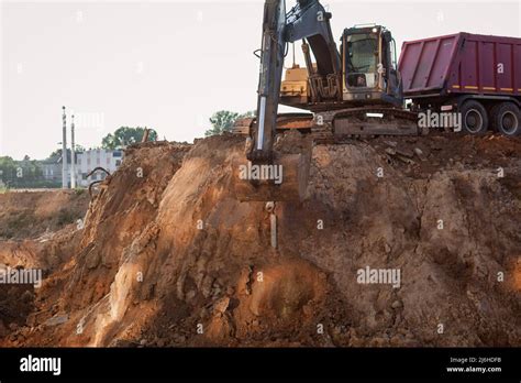 Large Constructions Excavator Of Yellow Color On The Construction Site