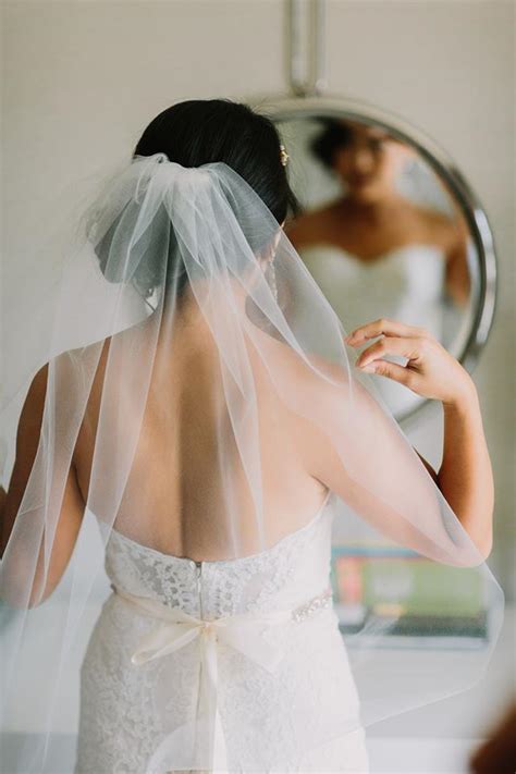 How To Best Wear A Wedding Veil With A Low Updo Bun Hairstyle One