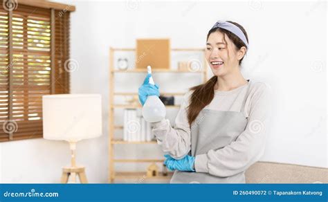 Beautiful Asian Housewife Wearing Apron And Cleaning Gloves Prepares To