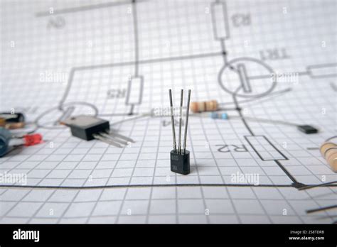 Electronic Components Standing On Circuit Diagram With Transistor And