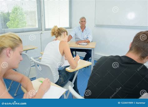 Students Passing Exam In Class Stock Image Image Of Education